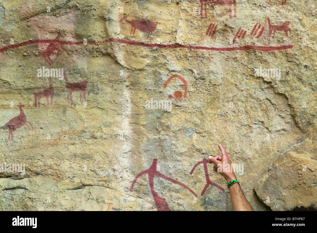 Finger pointing at Prehistorical paintings Walichu Caves El Calafate ...
