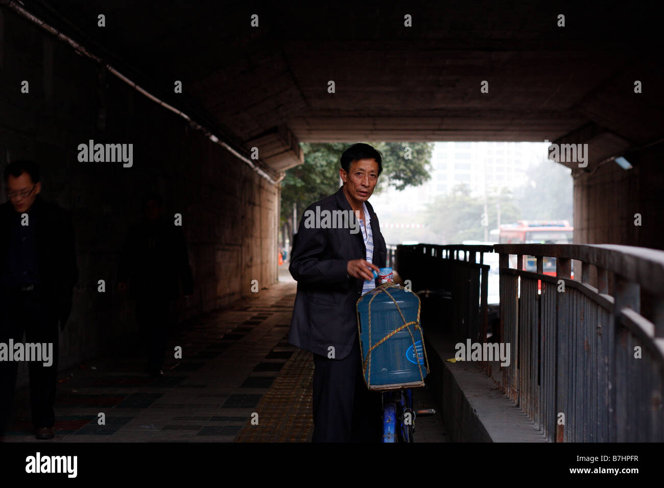 Water Delivery man standing under bridge Stock Photo - Alamy