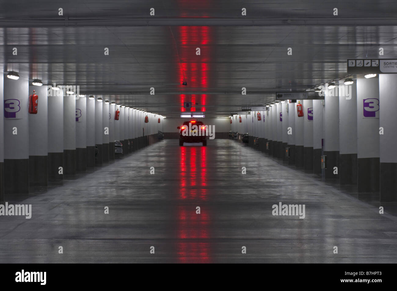 perspective in a underground garage, red stop lights of a car Stock ...