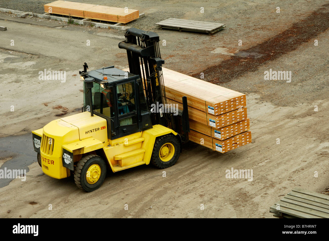 Lumber being moved at a forest products processing plant Stock Photo ...