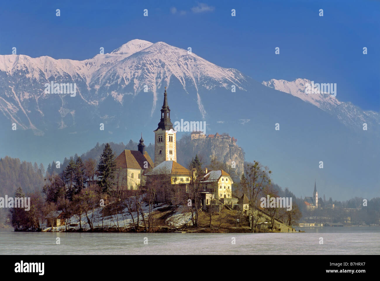 Church on Bled Island, Bled Castle behind and Karavanke Alps visible in ...