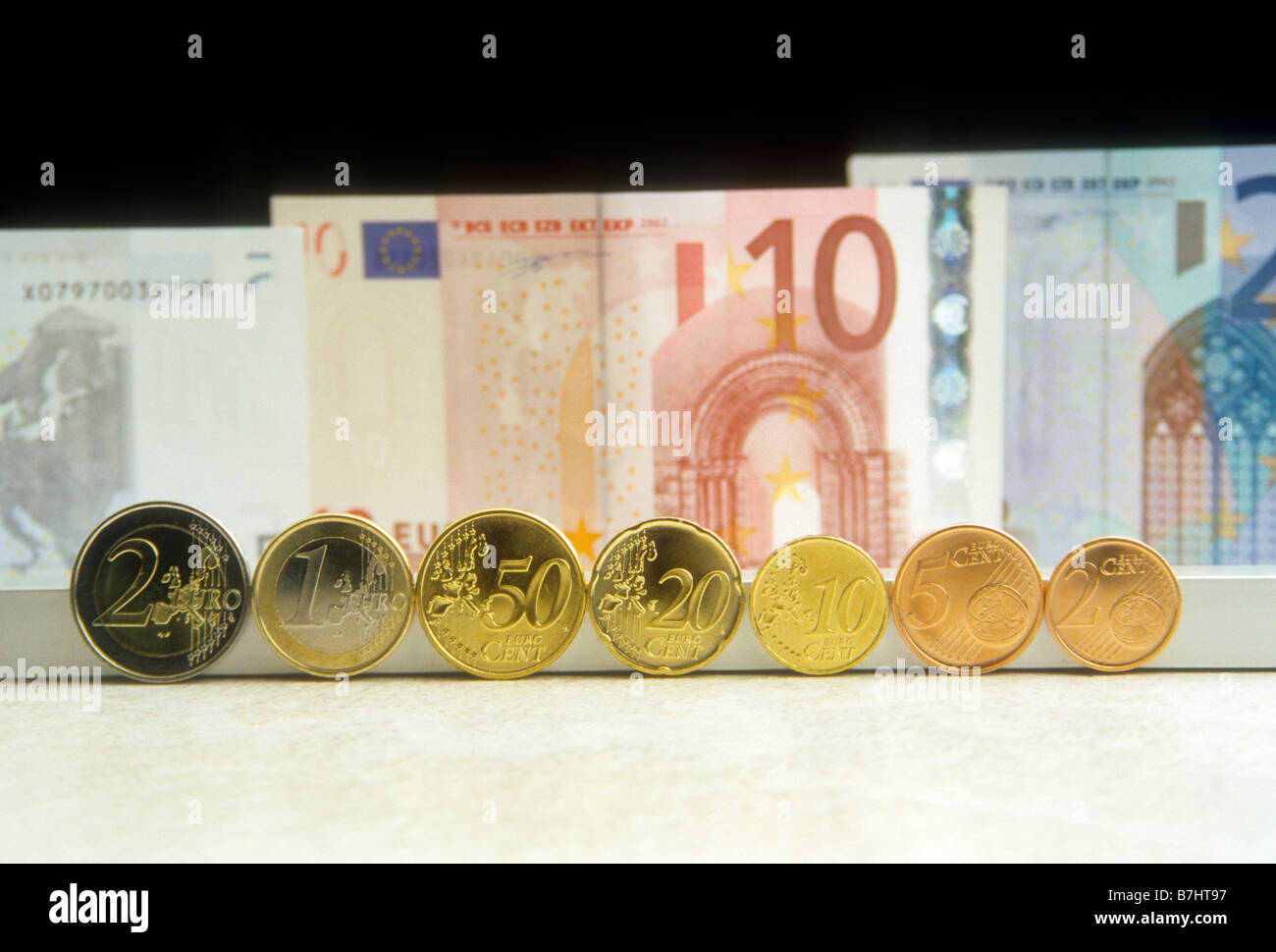 Row of Euro coins in front of variety of Euro paper currency Stock ...