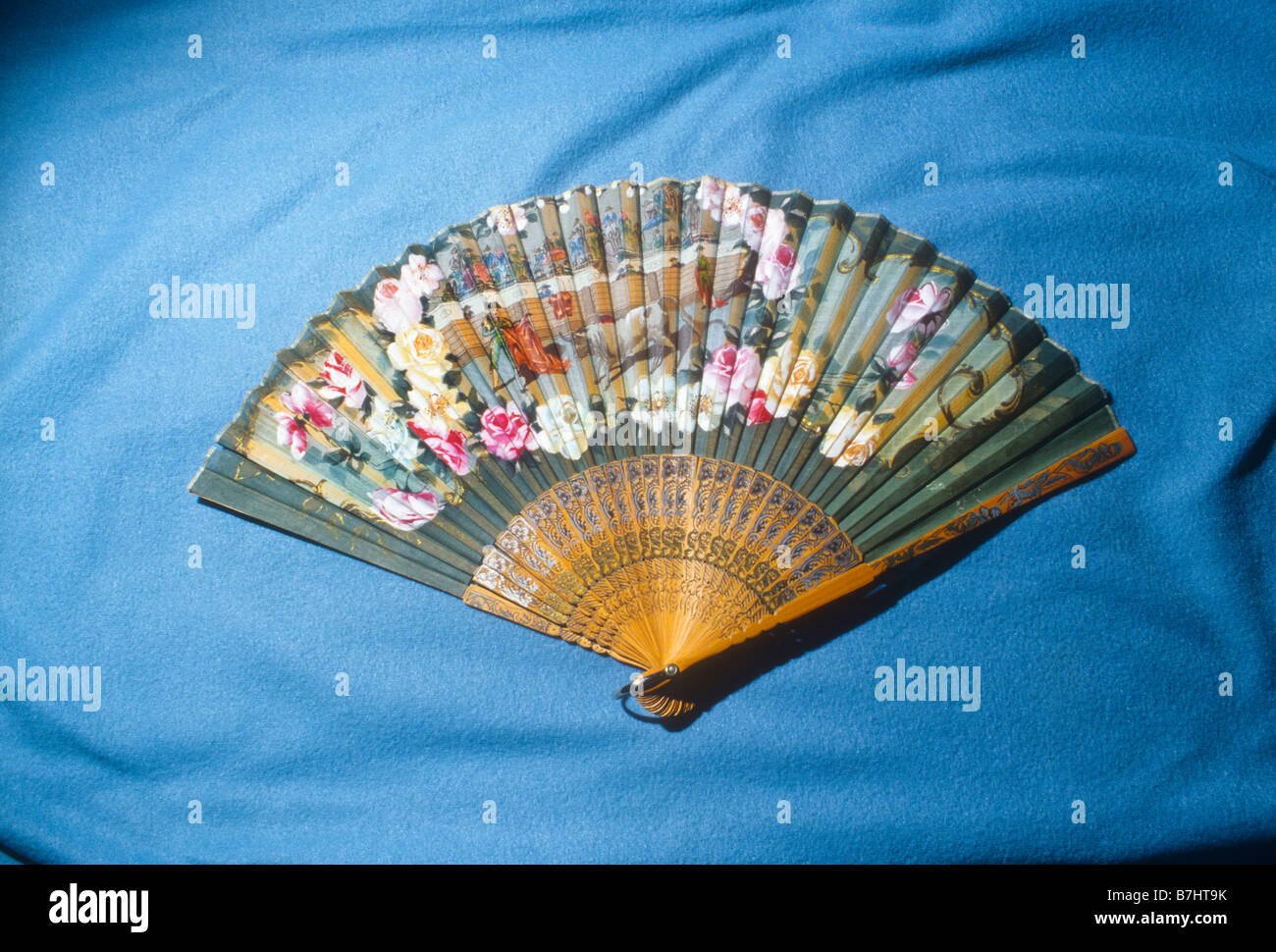 Painted Chinese fan open blue background Stock Photo - Alamy