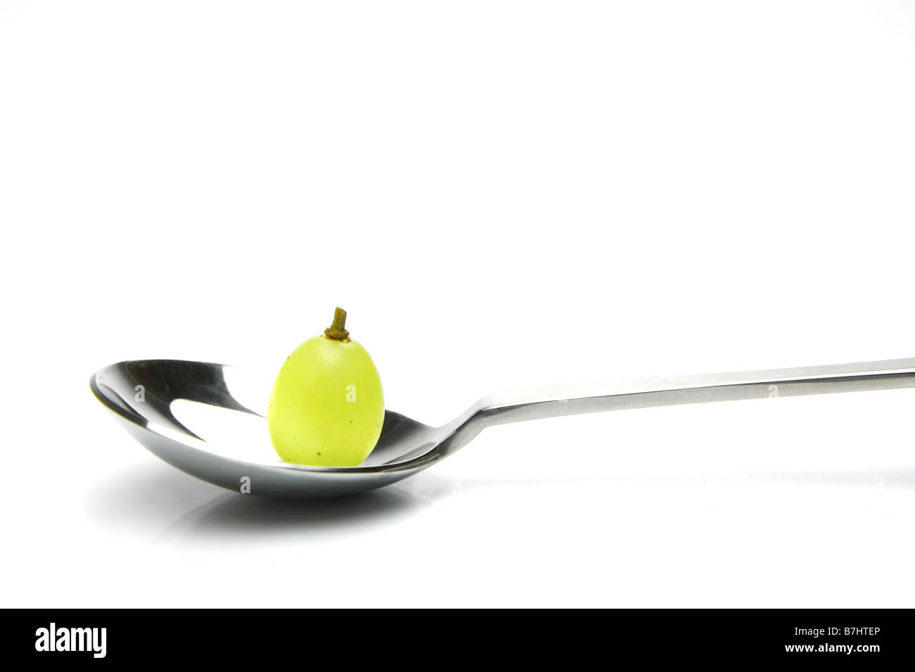 Grapes on a spoon isolated against a white background Stock Photo - Alamy