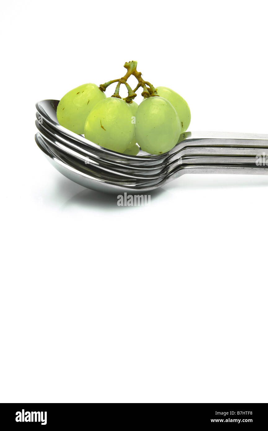 Grapes on a spoon isolated against a white background Stock Photo - Alamy