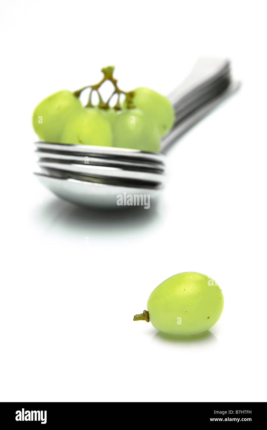 Grapes on a spoon isolated against a white background Stock Photo - Alamy