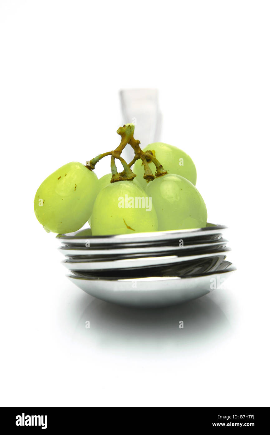 Grapes on a spoon isolated against a white background Stock Photo - Alamy