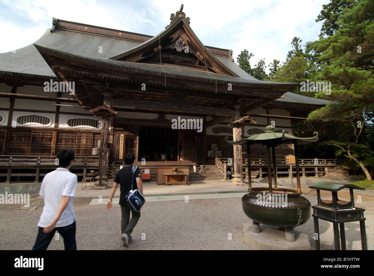 A worshipper approaches a temple building at Chusonji temple, Hiraizumi ...