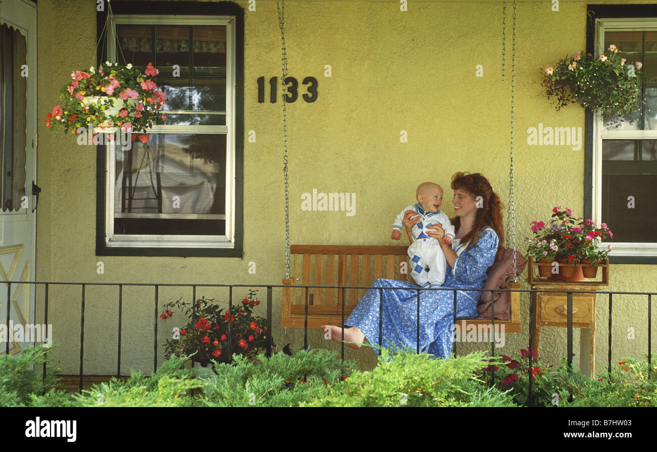 Mother & baby on front porch swing Stock Photo - Alamy