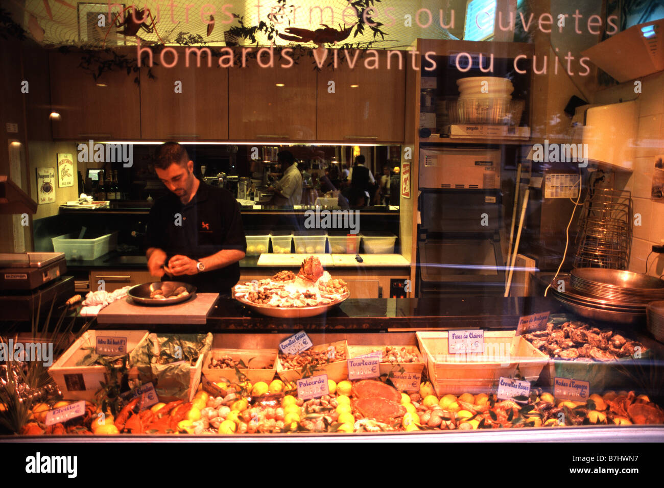 Cook in restaurant window Stock Photo - Alamy