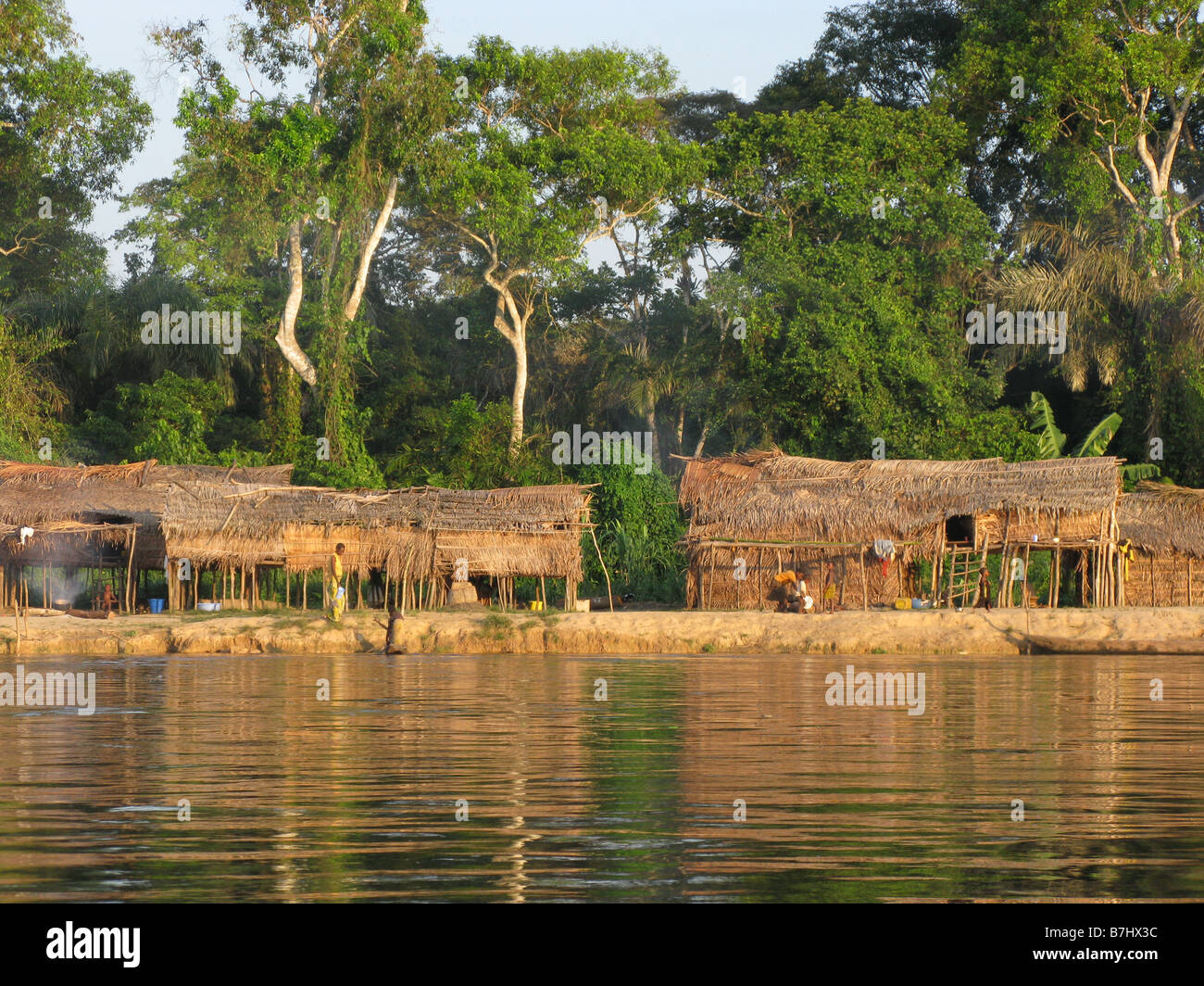 Fishing village thatched roofed huts of grass and reeds set on stilts ...