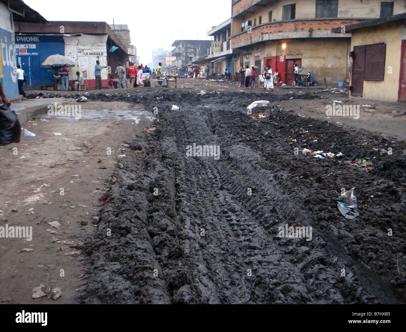 Muddy street in Kinshasa Democratic Republic of Congo with tyre tracks ...