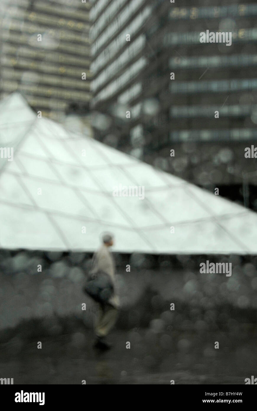 A man seen through a window walks in the rain in Boston Stock Photo - Alamy