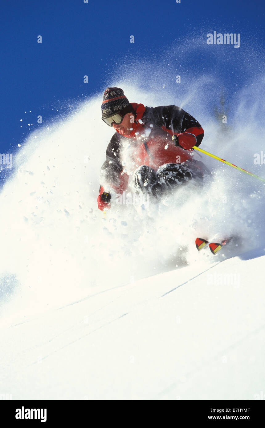Young man skiing fresh powder on steep slope at Island Lake Resort ...