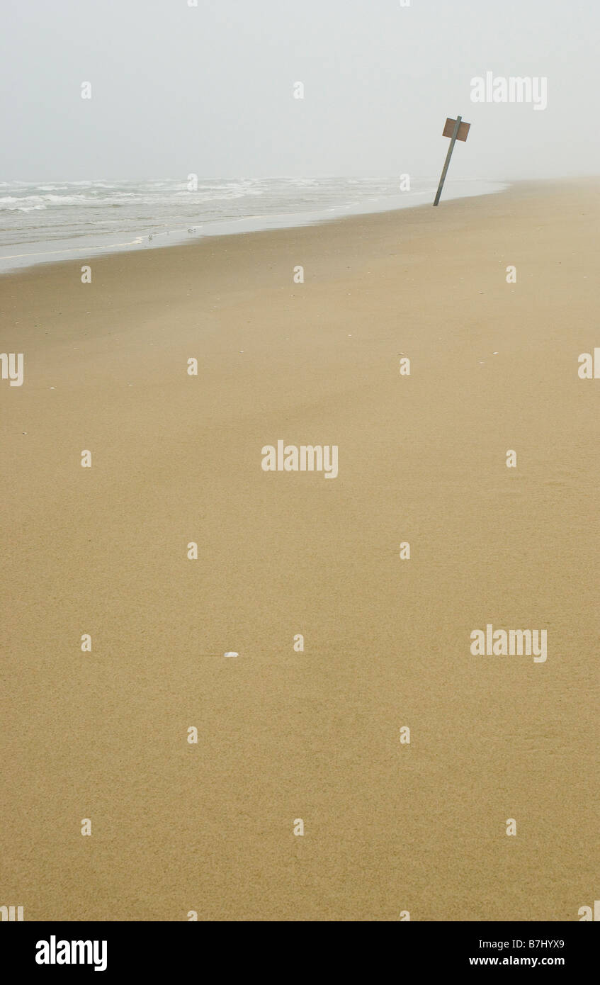 Sign on flat sandy beach with mist in the background, Reedsport, Oregon ...