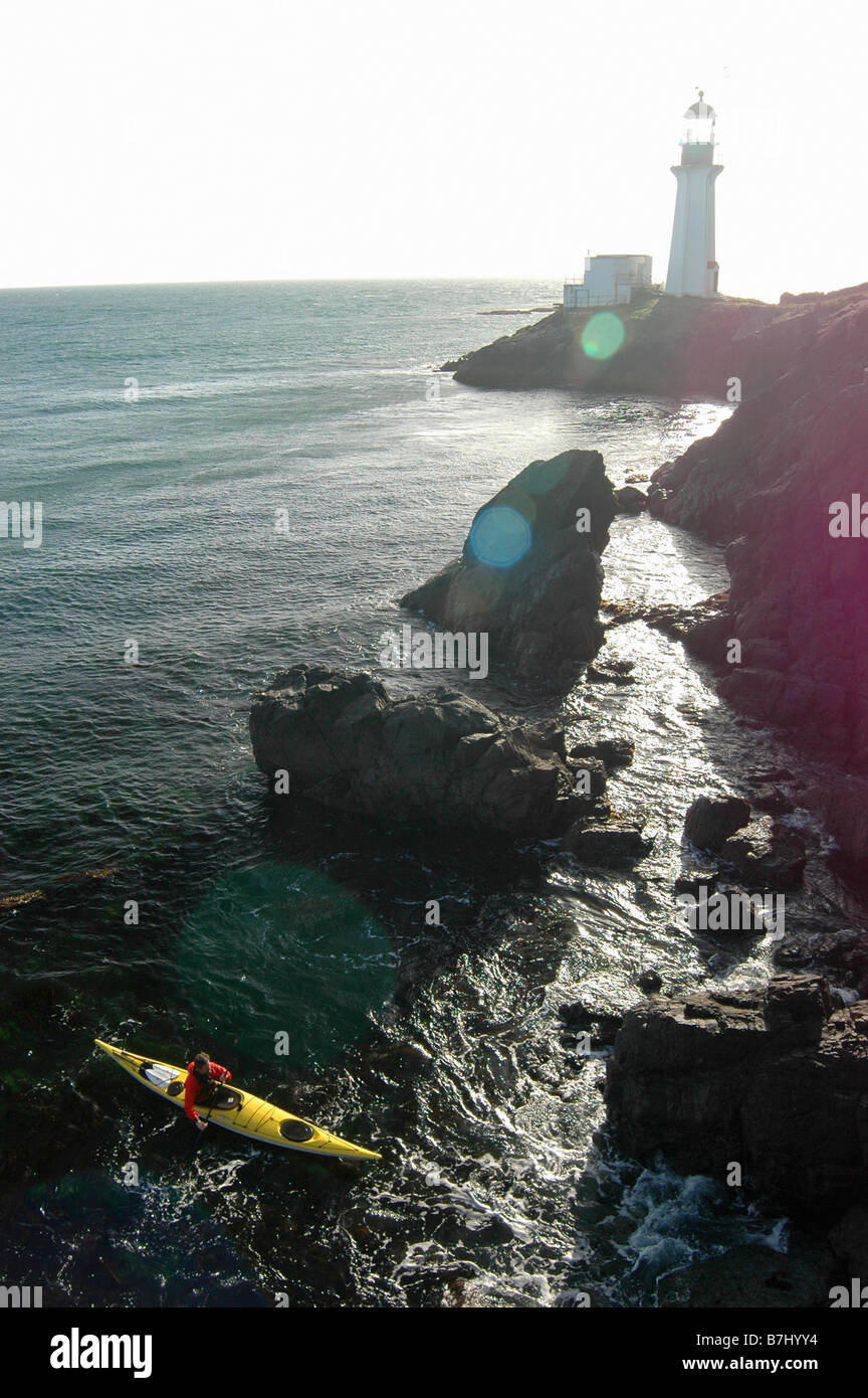 Man (30-35) kayaking in front of a lighthouse, Jordan River, B.C Stock ...