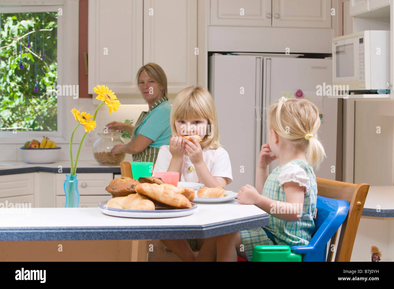 Mom and 3 and 5 year old daughters having breakfast, B.C Stock Photo ...