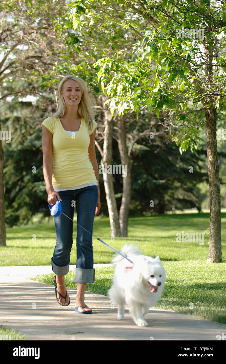 Young woman walking dog in park, Regina, Saskatchewan Stock Photo - Alamy