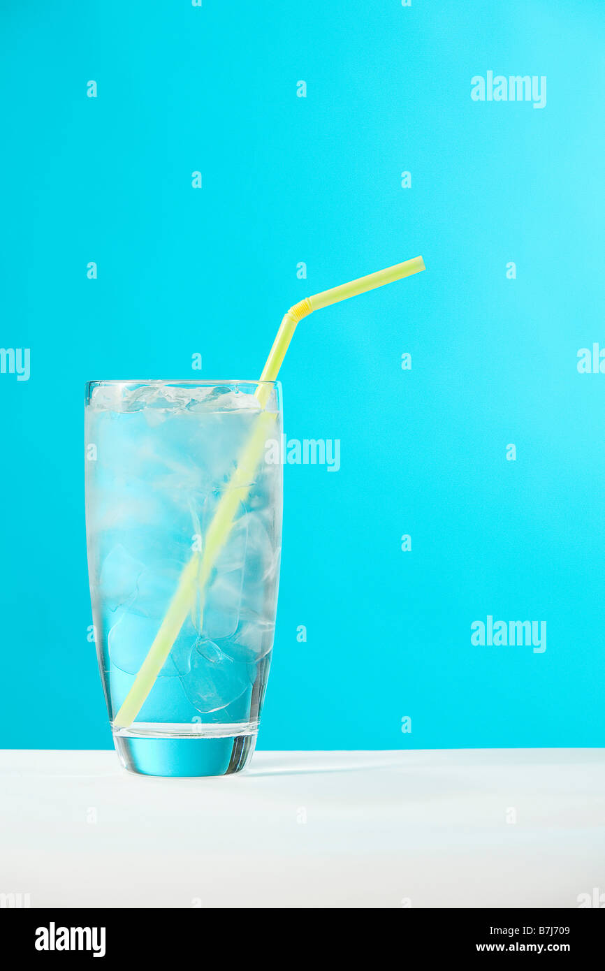 Very full glass of water with ice and yellow drinking straw Stock Photo ...
