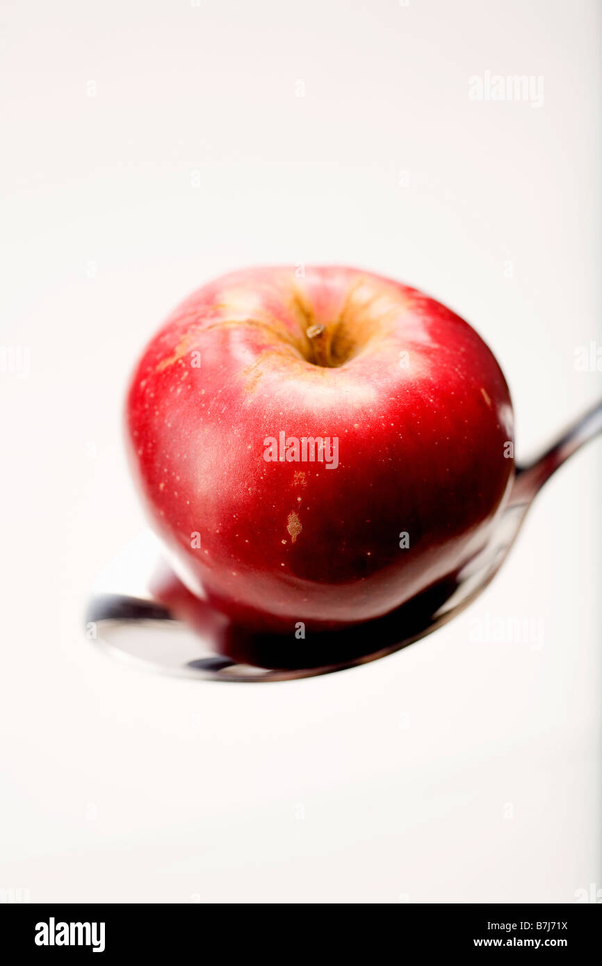 Organic apple in spoon Stock Photo - Alamy