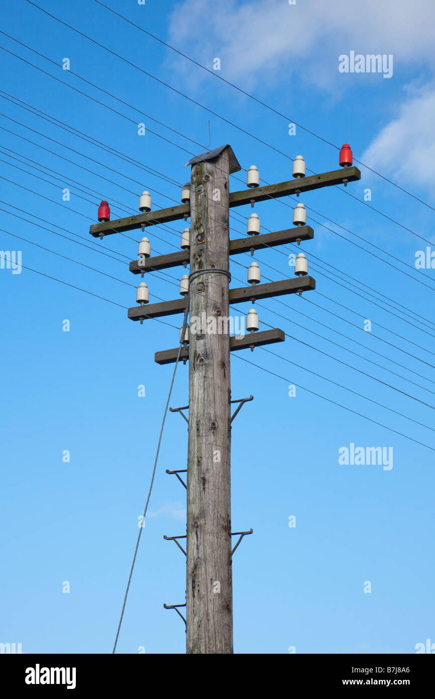 Telegraph pole against blue sky Stock Photo - Alamy