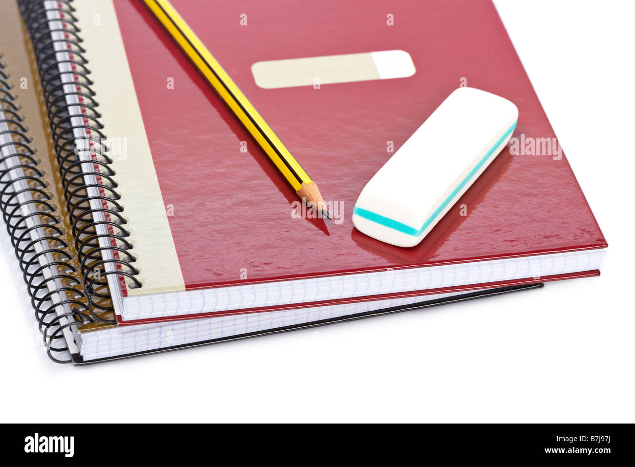 Pencil and eraser on a two notebooks with soft shadow on white ...