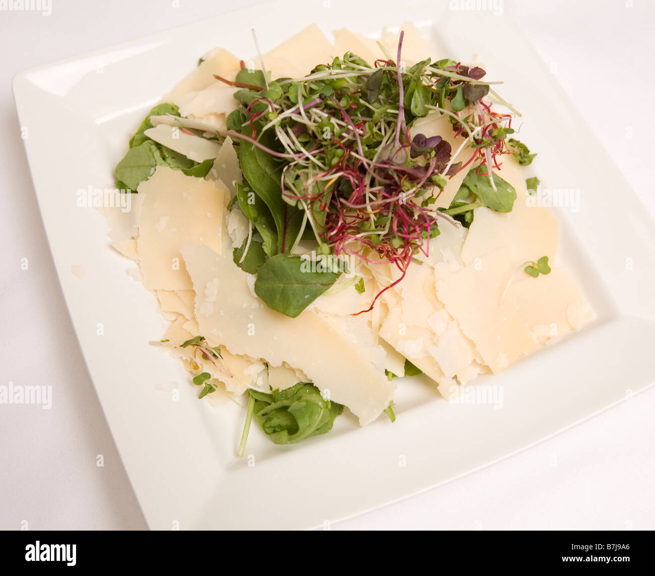 Shaved Parmesan cheese with salad Stock Photo - Alamy
