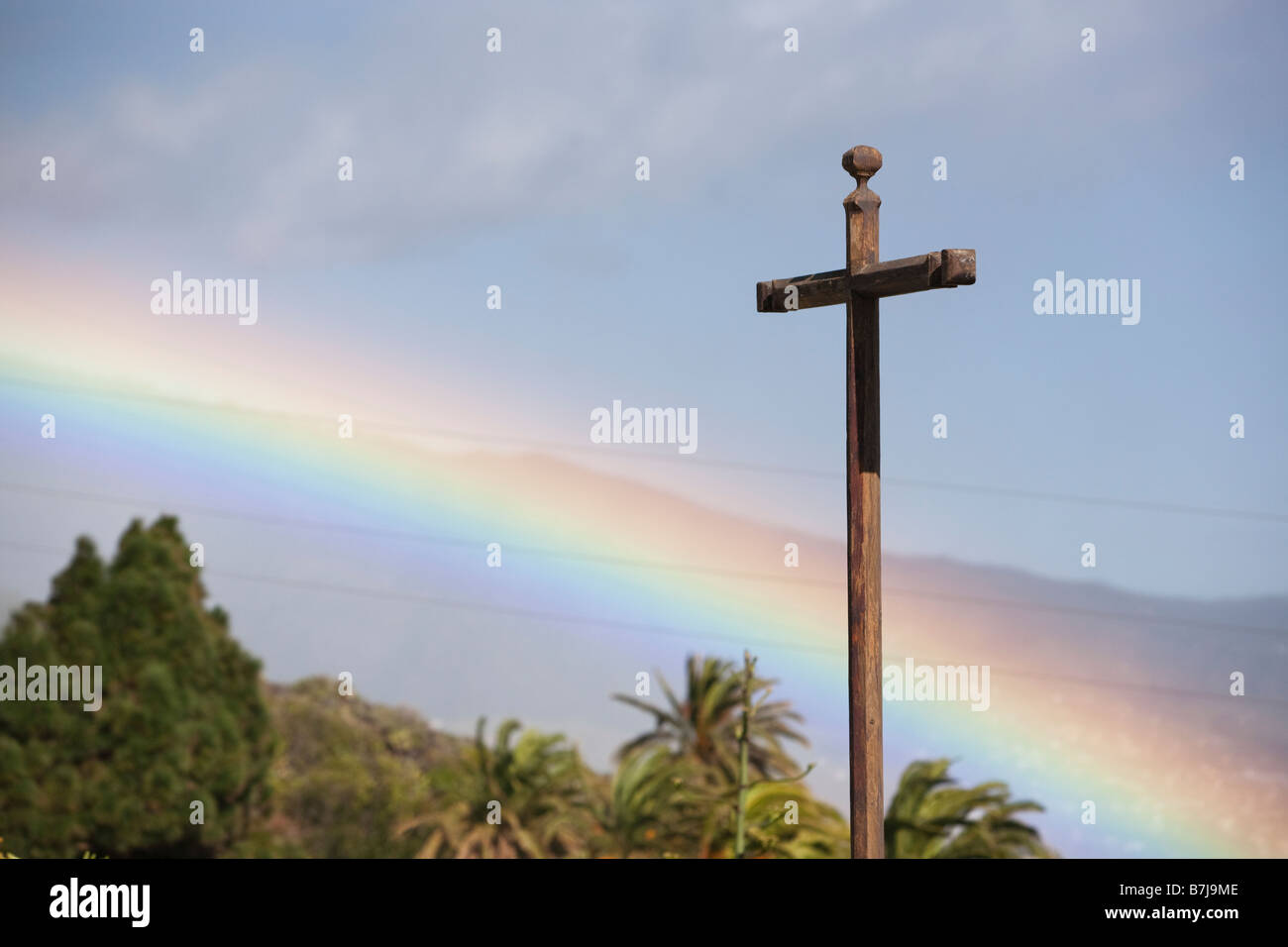 A beautiful rainbow and a christian cross Stock Photo - Alamy