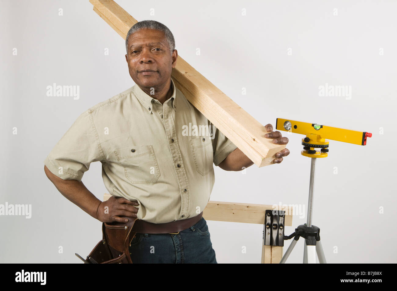 African American Man Doing Home Improvement, Carrying 2x4 Lumber Over ...