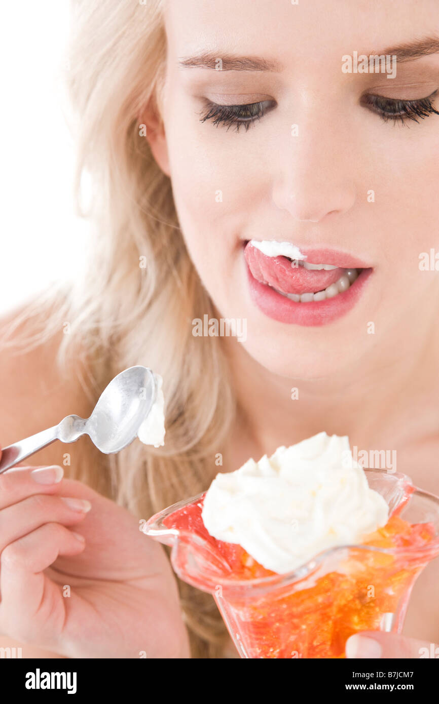 Woman eating jelly with cream Stock Photo - Alamy