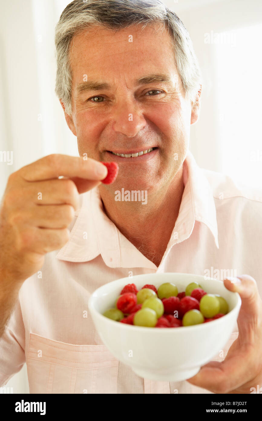 Middle Aged Man Eating Fresh Fruit Stock Photo - Alamy