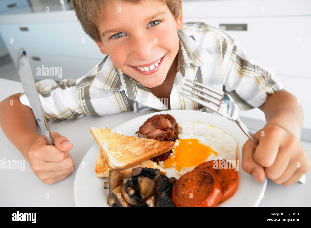 Young Boy Eating Unhealthy Fried Breakfast Stock Photo - Alamy