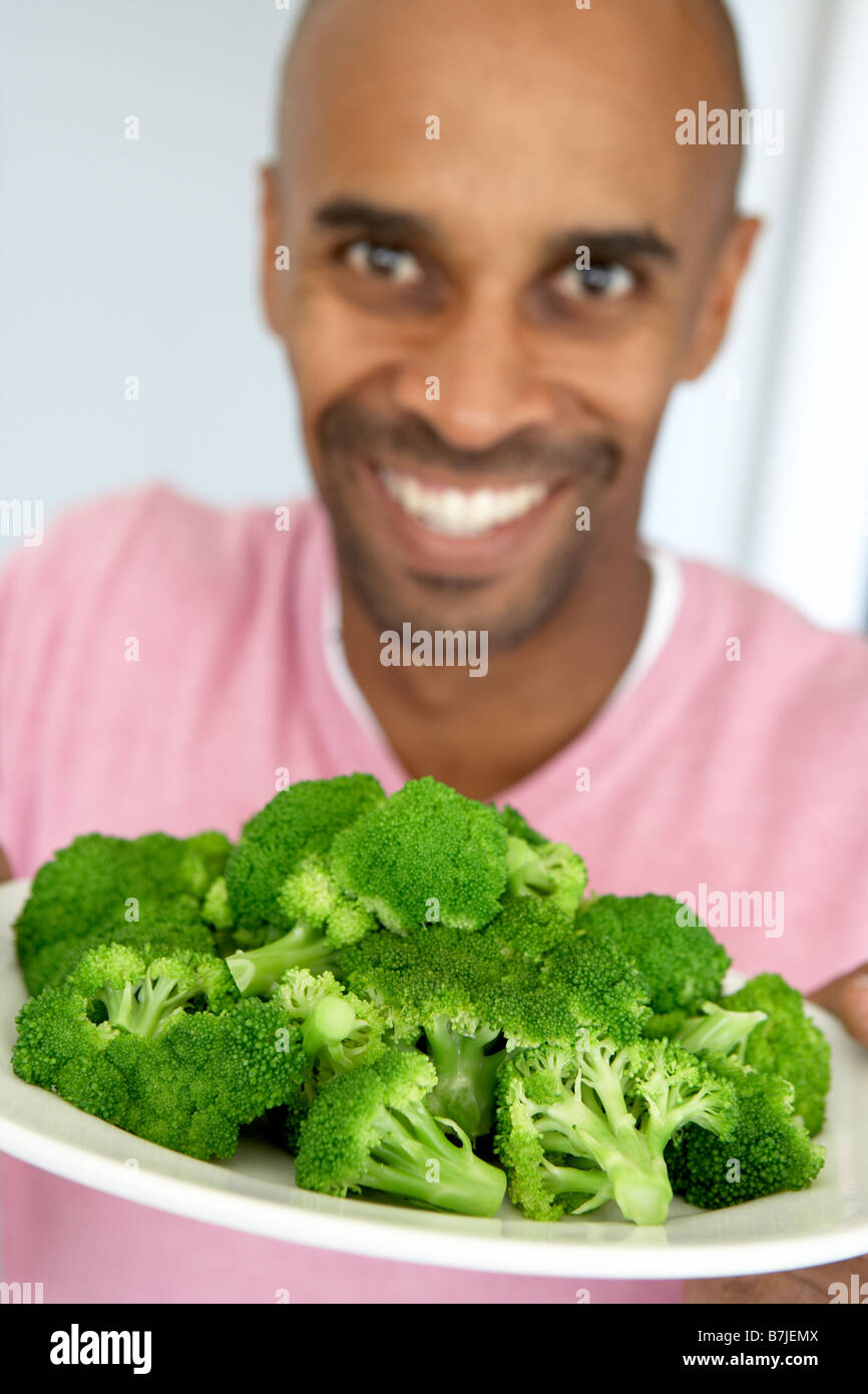 Middle Aged Man Holding A Plate Of Broccoli Stock Photo - Alamy