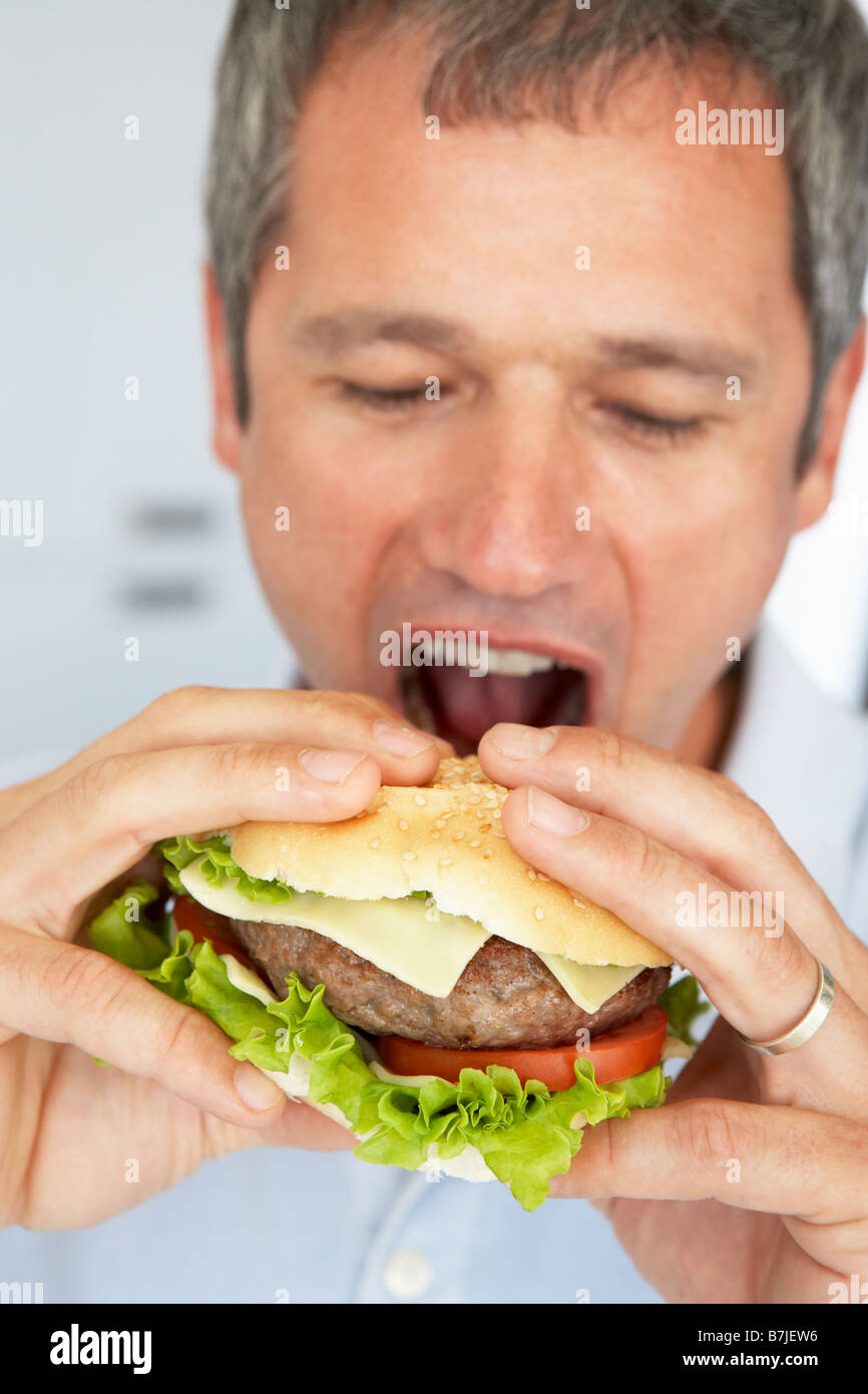 Middle Aged Man Eating A Burger Stock Photo - Alamy