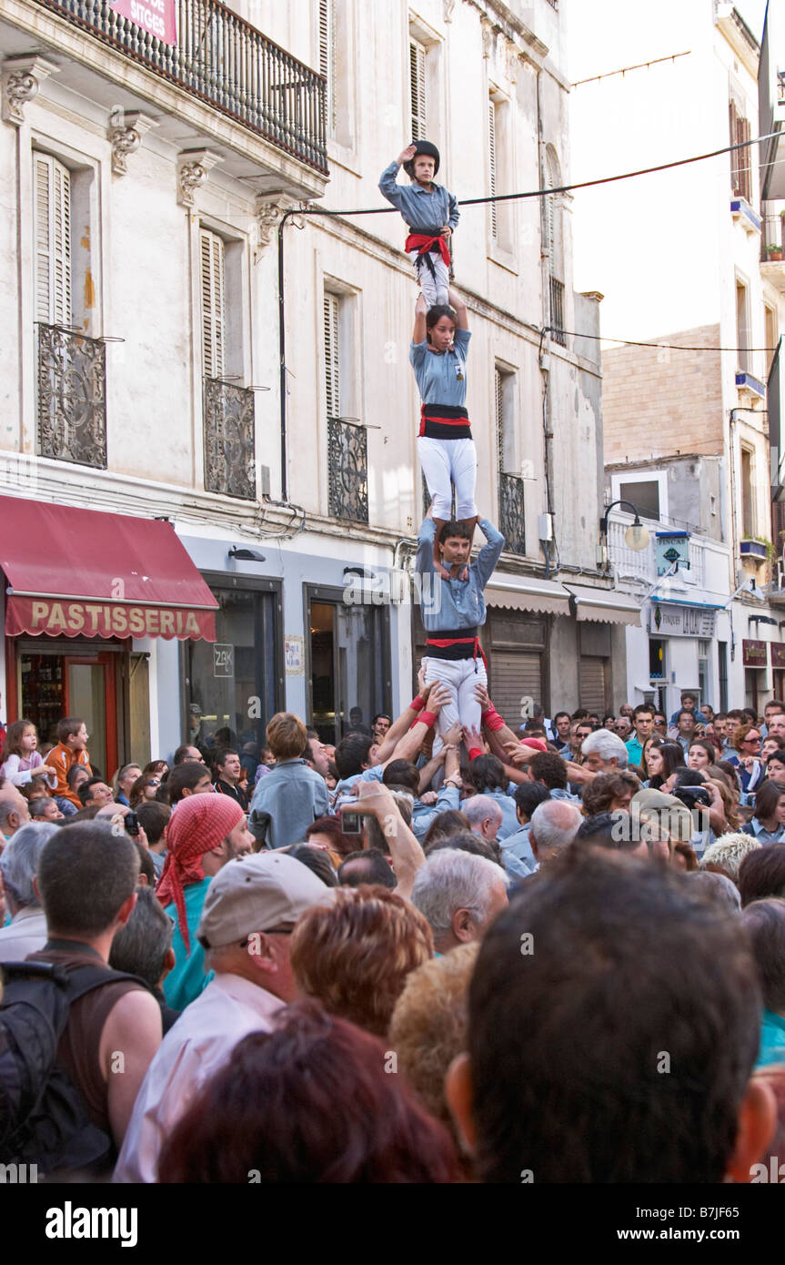 Human tower competition, castellers, Child on top raises hand: finished ...