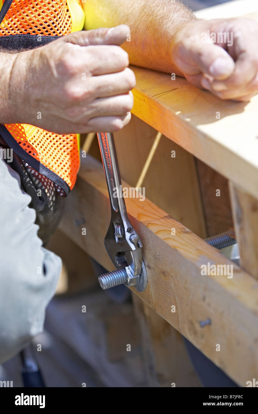 Worker tightening a bolt with a wrench; Canada, Ontario, Hamilton ...
