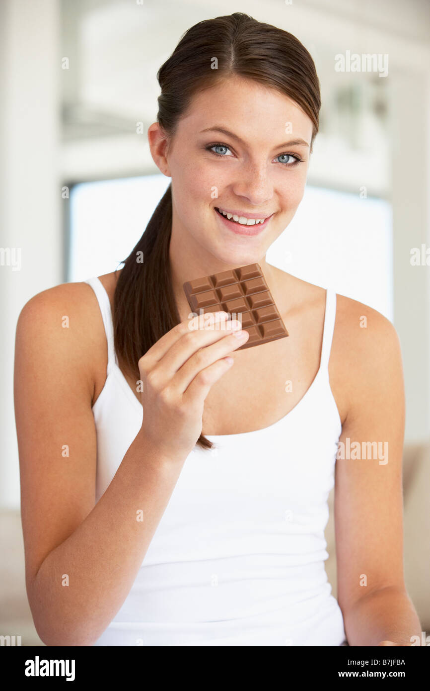 Young Woman Eating Chocolate Stock Photo - Alamy