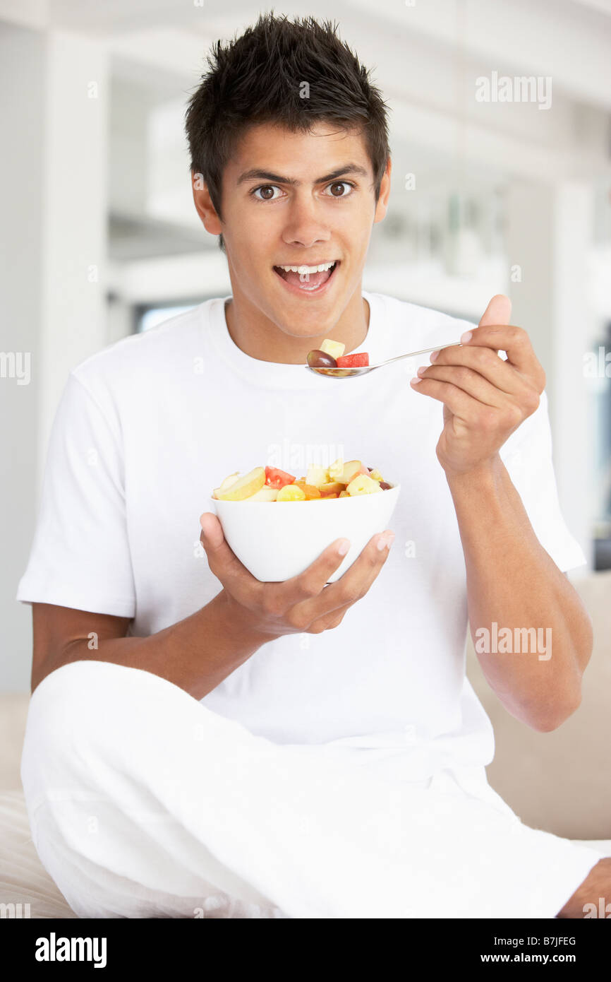 Young Man Eating Fresh Fruit Salad Stock Photo - Alamy