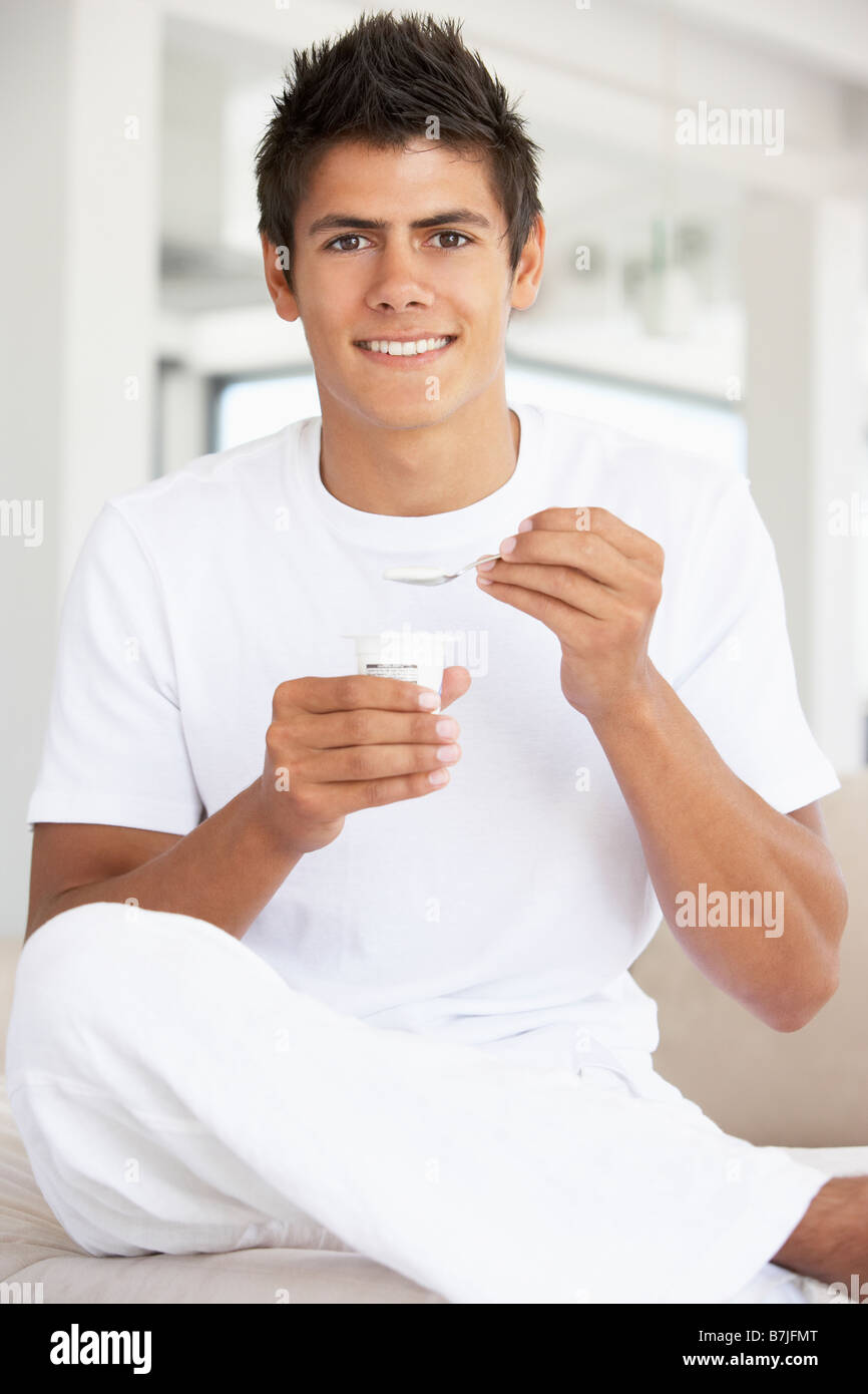 Young Man Eating Yogurt Stock Photo - Alamy