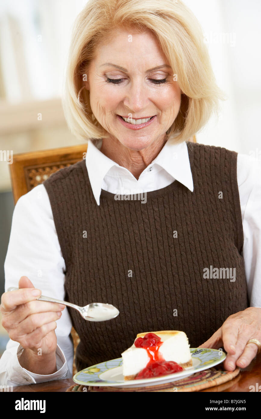 Senior Woman Eating Cheesecake Stock Photo - Alamy