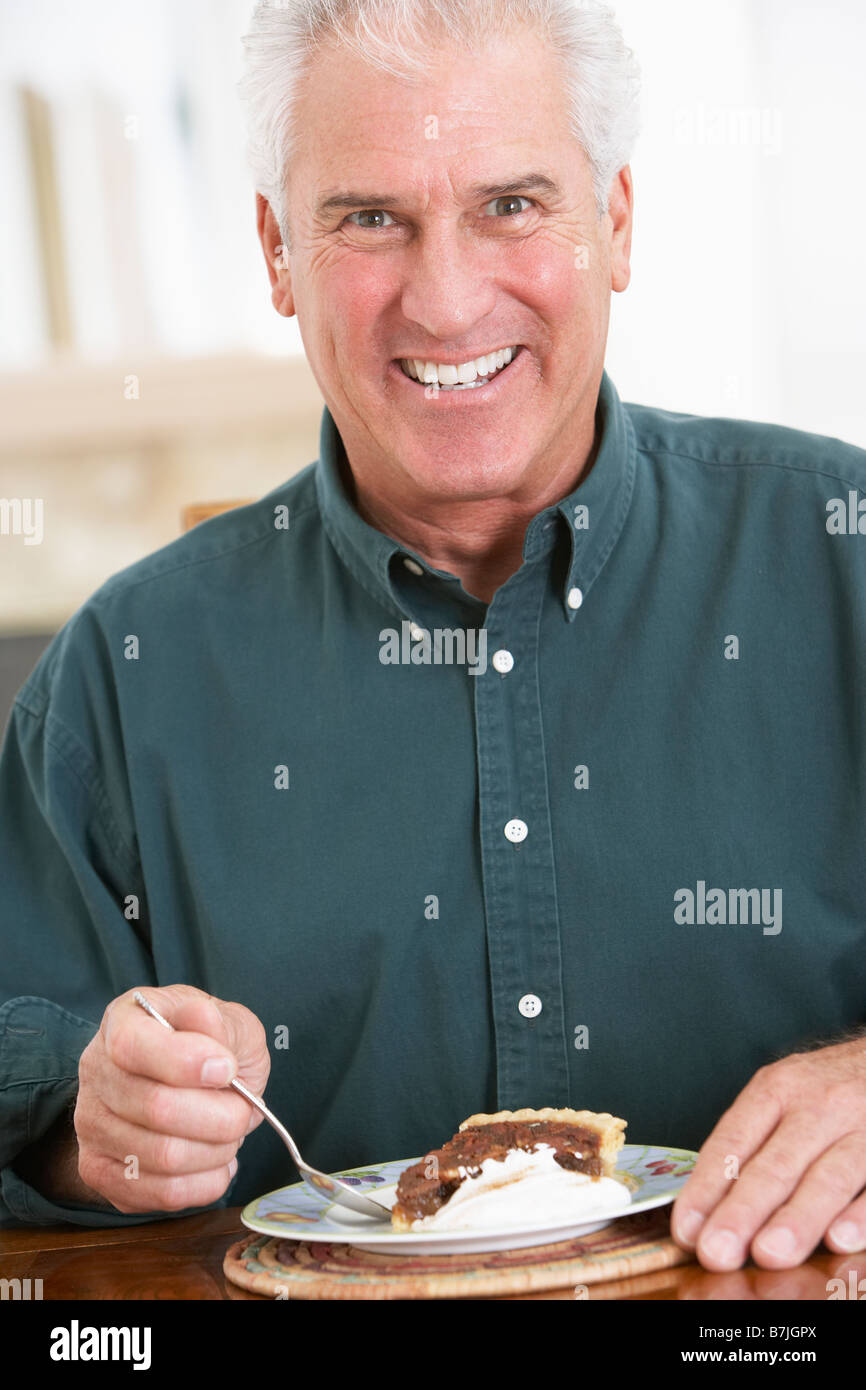 Old senior man eating chocolate hi-res stock photography and images - Alamy