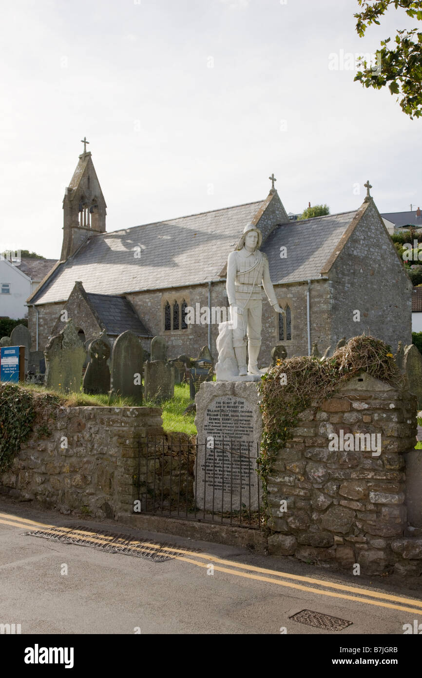 The church in Port Eynon with memorial statue of Lifeboat crewman Stock ...