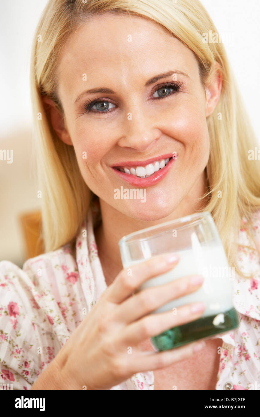 Mid Adult Woman Holding Glass Of Milk, Smiling At Camera Stock Photo ...