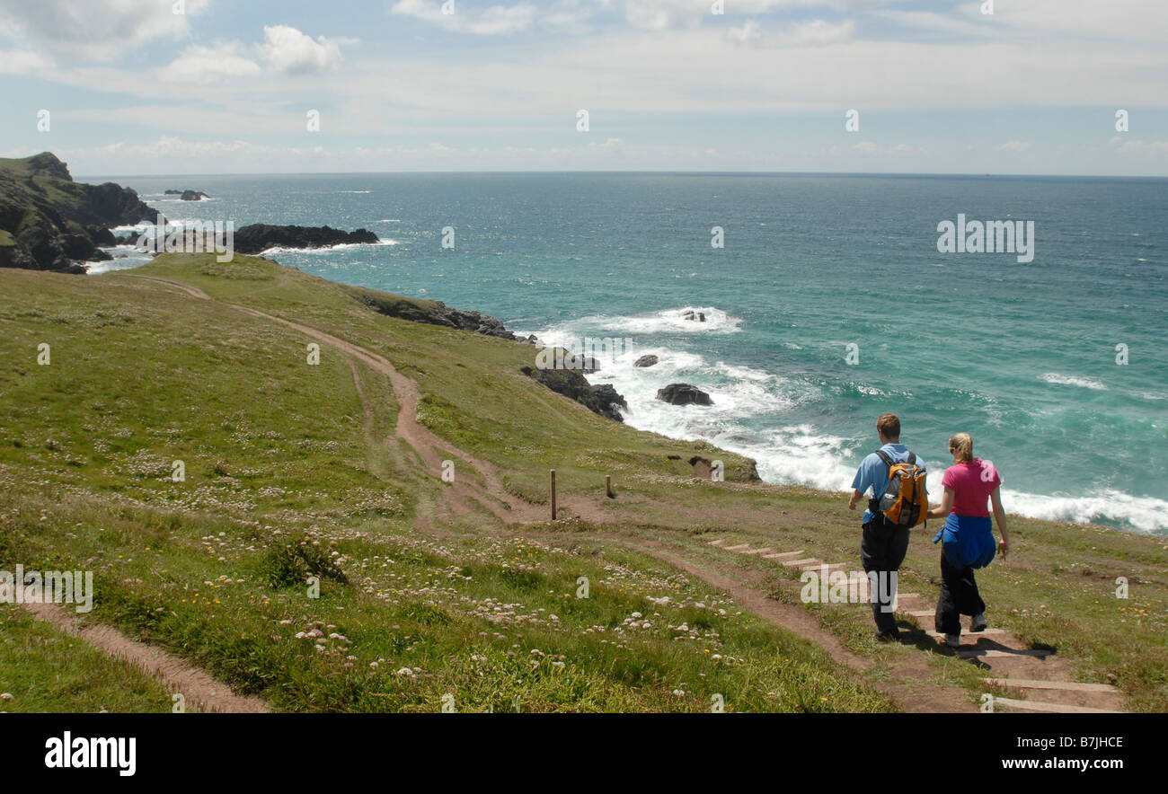The Lizard Peninsula, Cornwall, England. A couple walk along the ...