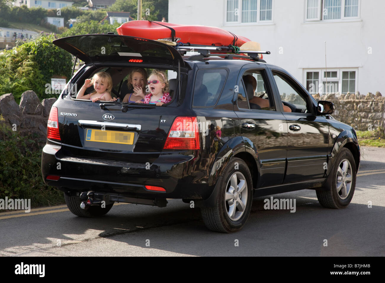 Three young girls riding in the back of a 4x4 vehicle Stock Photo - Alamy