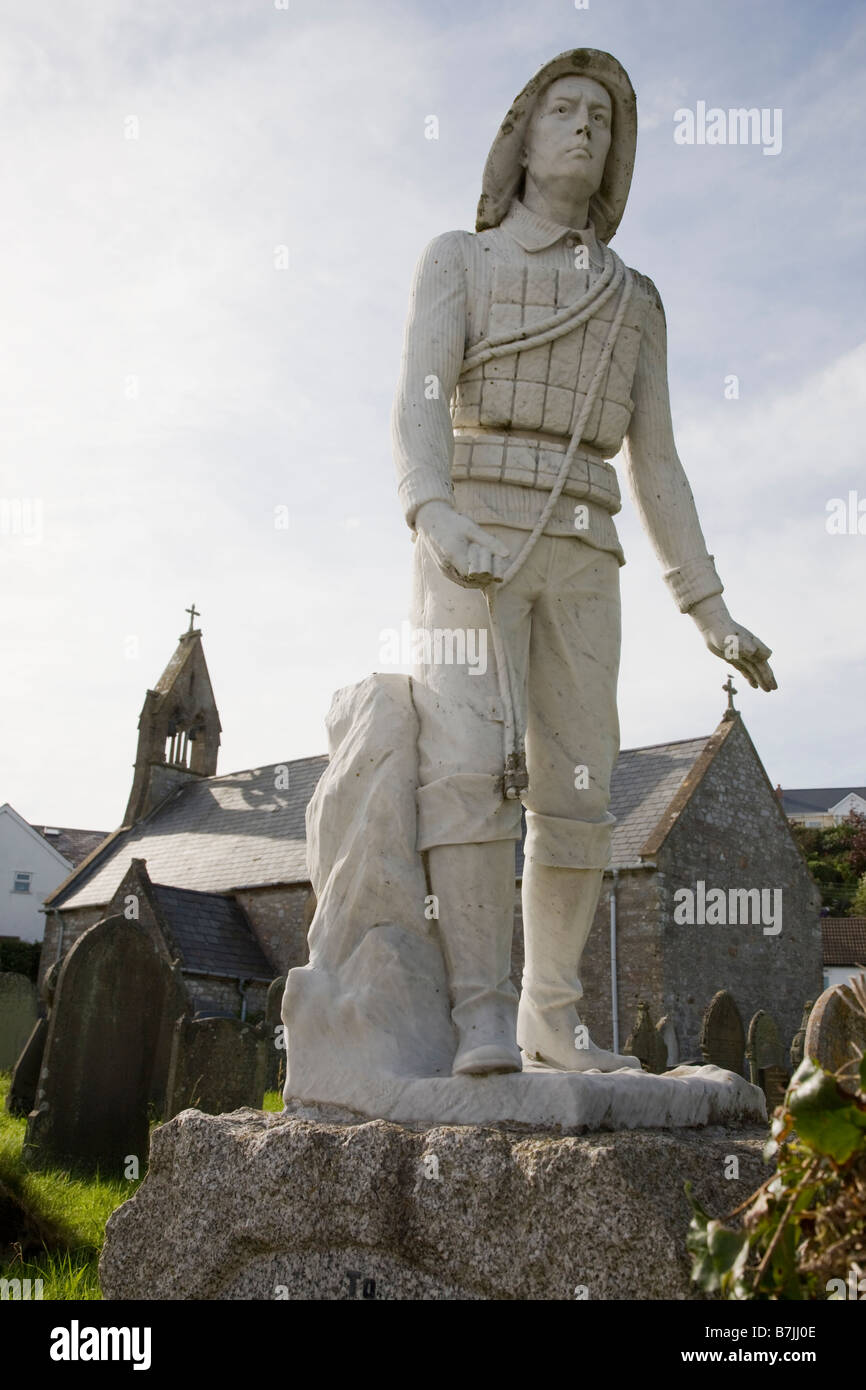 The church in Port Eynon with memorial statue of Lifeboat crewman Stock ...