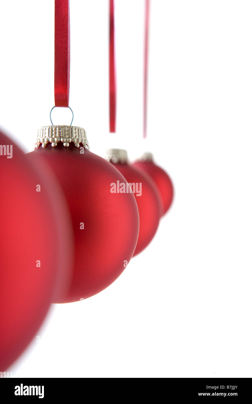 Line Of Red Christmas Decorations Hanging Against White Background ...
