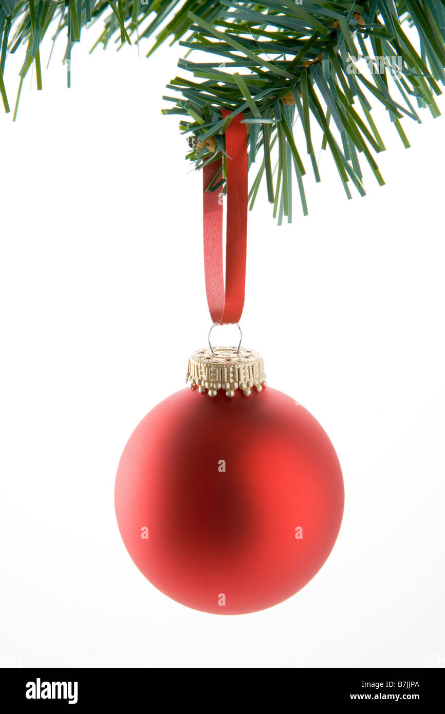 Red Bauble Hanging From Tree Against White Background Stock Photo - Alamy