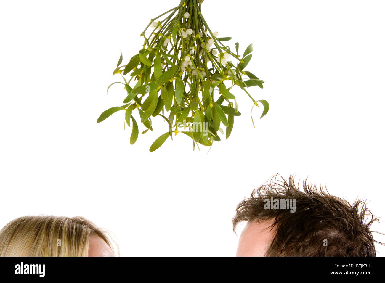Detail Of Couple Standing Beneath Bunch Of Mistletoe Stock Photo - Alamy