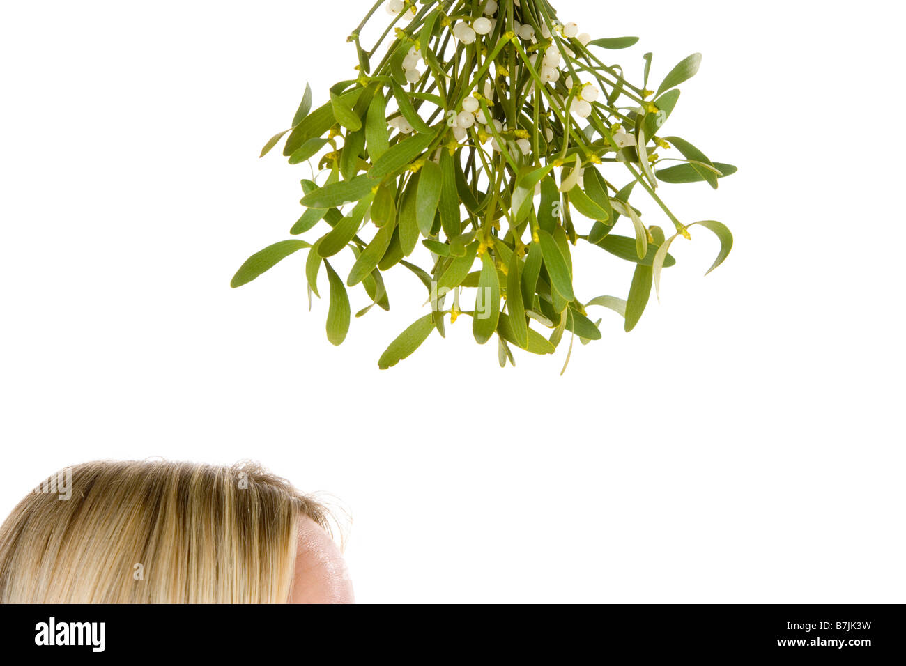 Woman Standing Under Bunch Of Mistletoe Against White Background Stock ...